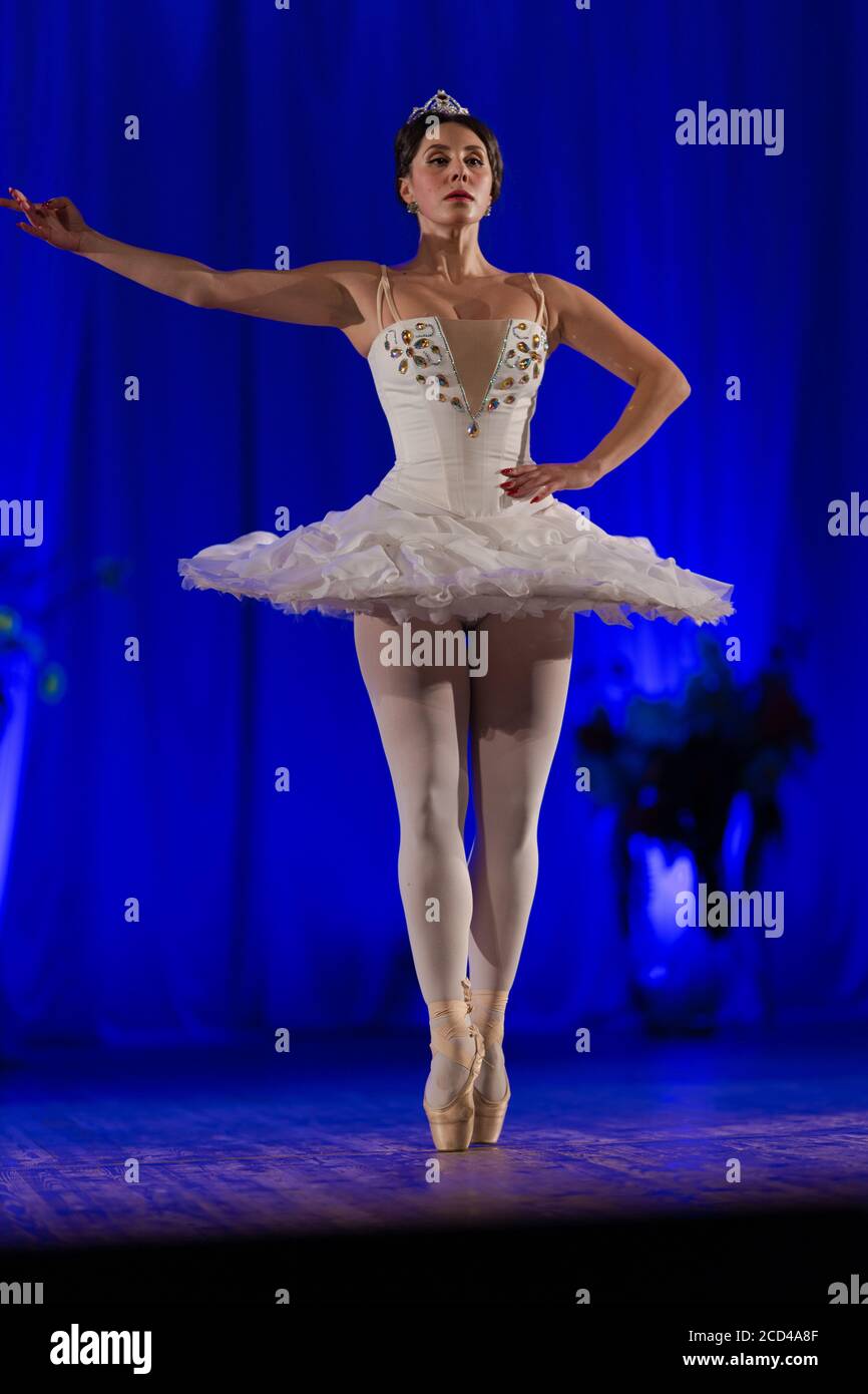 Young girl ballerina in a light blue dress tutu dancing performance of ...