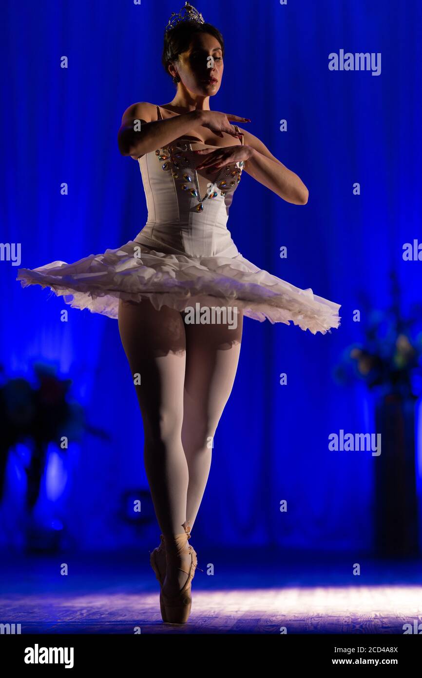 Young girl ballerina in a light blue dress tutu dancing performance of ...