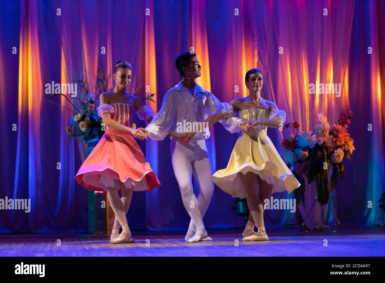Trio of young girls ballerinas and a young man dancing ballet ...
