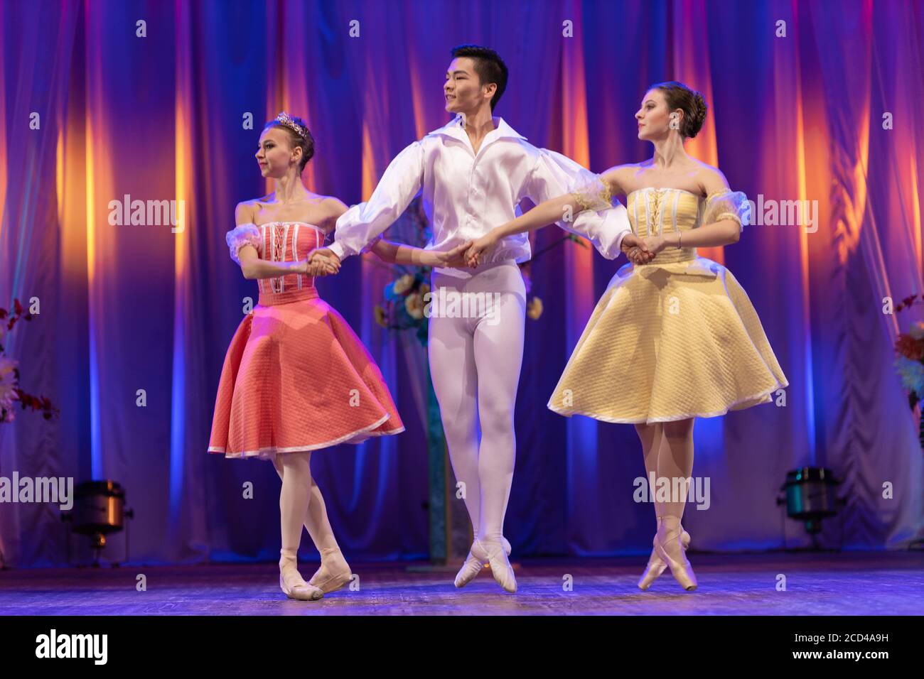 Trio of young girls ballerinas and a young man dancing ballet ...