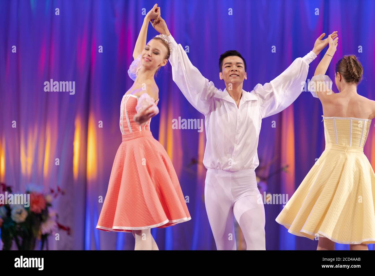 Trio of young girls ballerinas and a young man dancing ballet ...