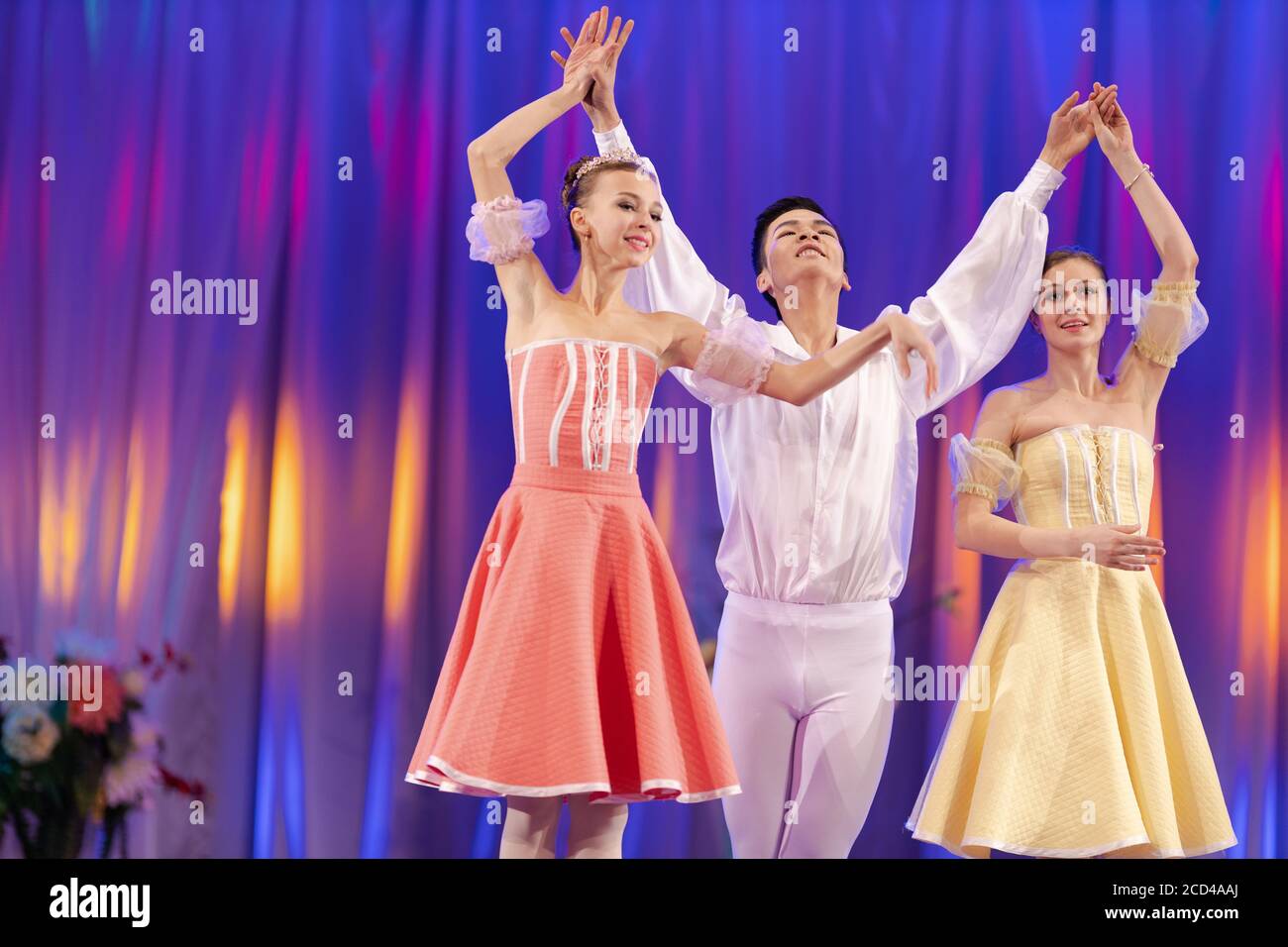 Trio of young girls ballerinas and a young man dancing ballet ...