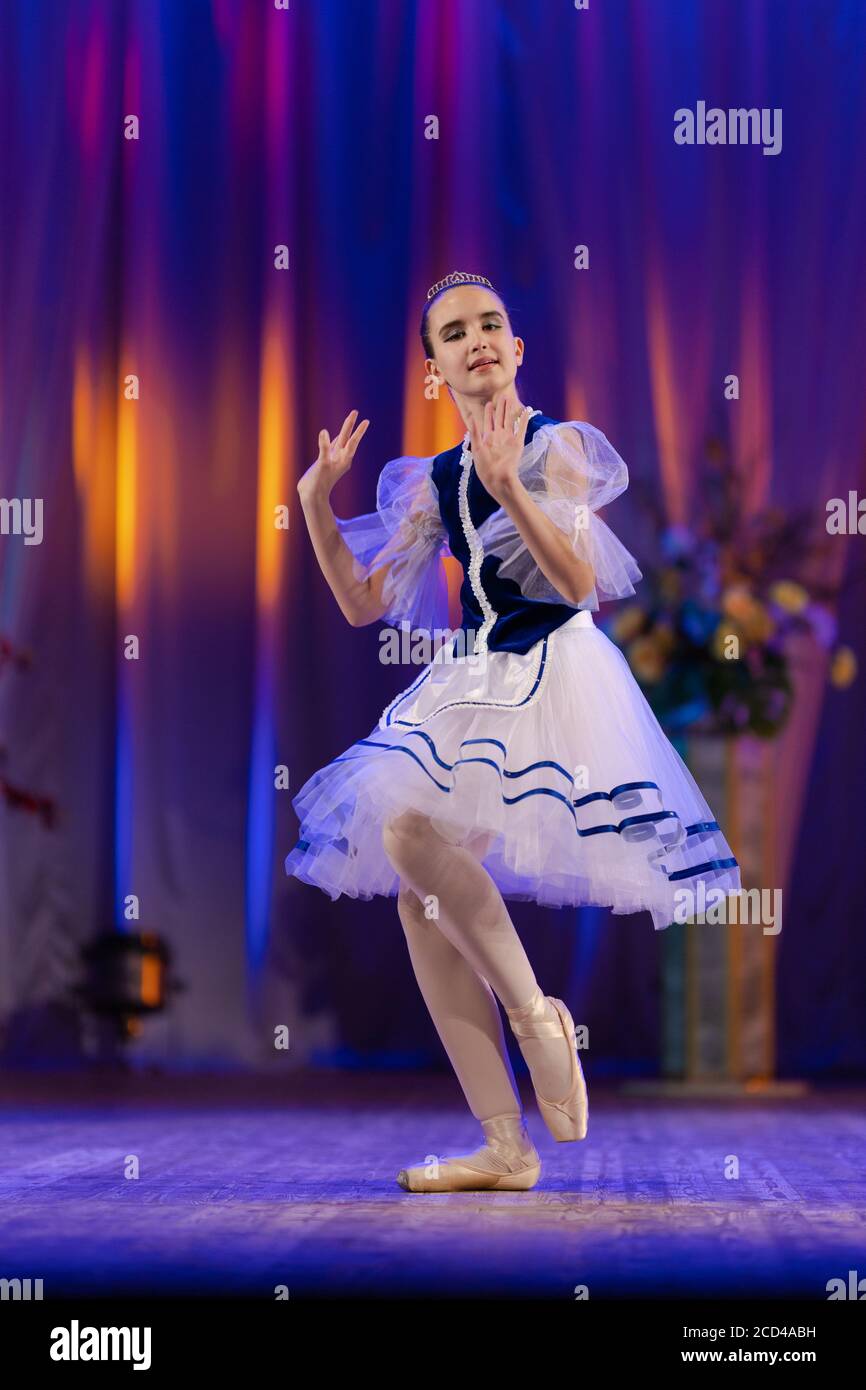 Trio of young girls ballerinas and a young man dancing ballet ...