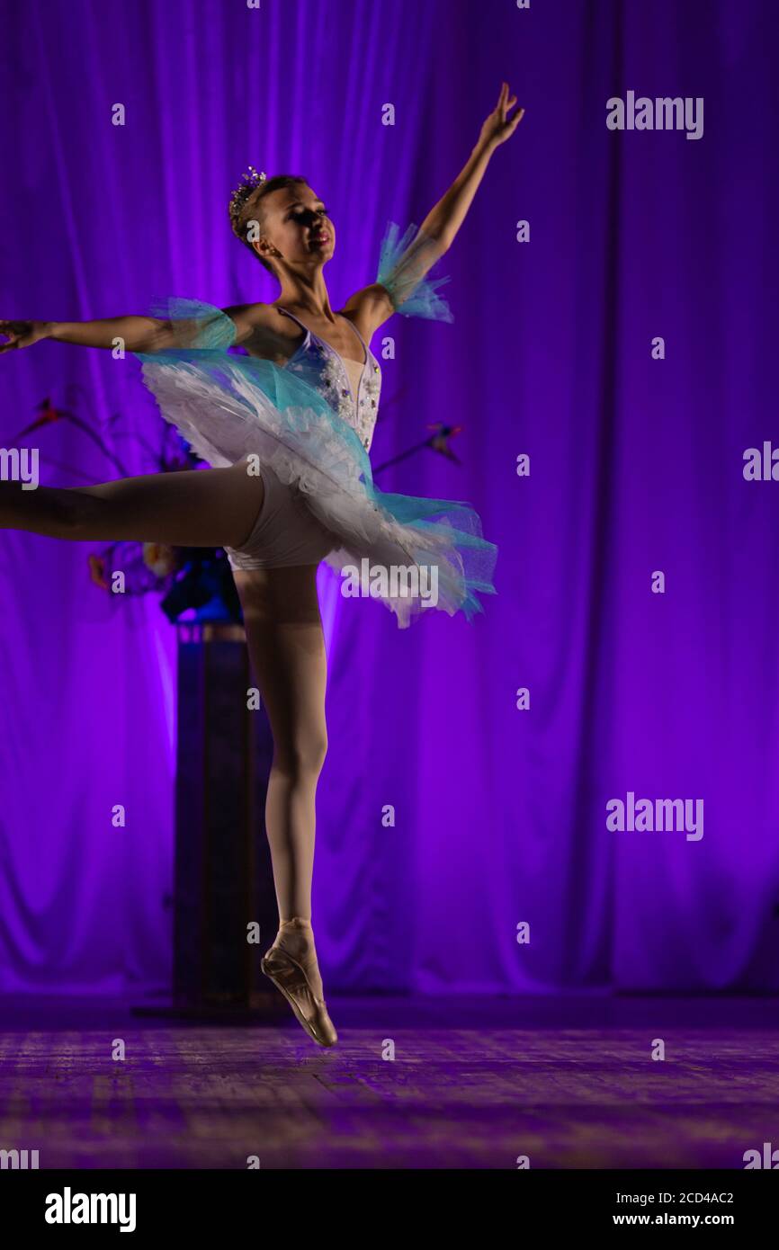 Young girl ballerina in a light blue dress tutu dancing performance of ...