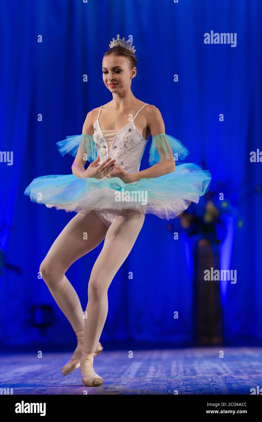 Young girl ballerina in a light blue dress tutu dancing performance of ...