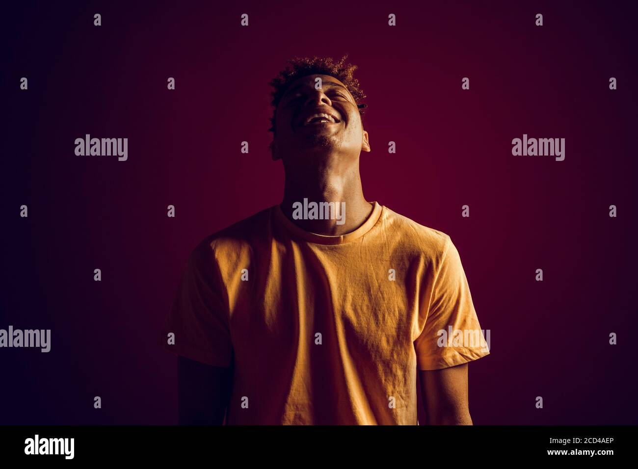 Young adult model man looking up and laughing cheerful Stock Photo - Alamy