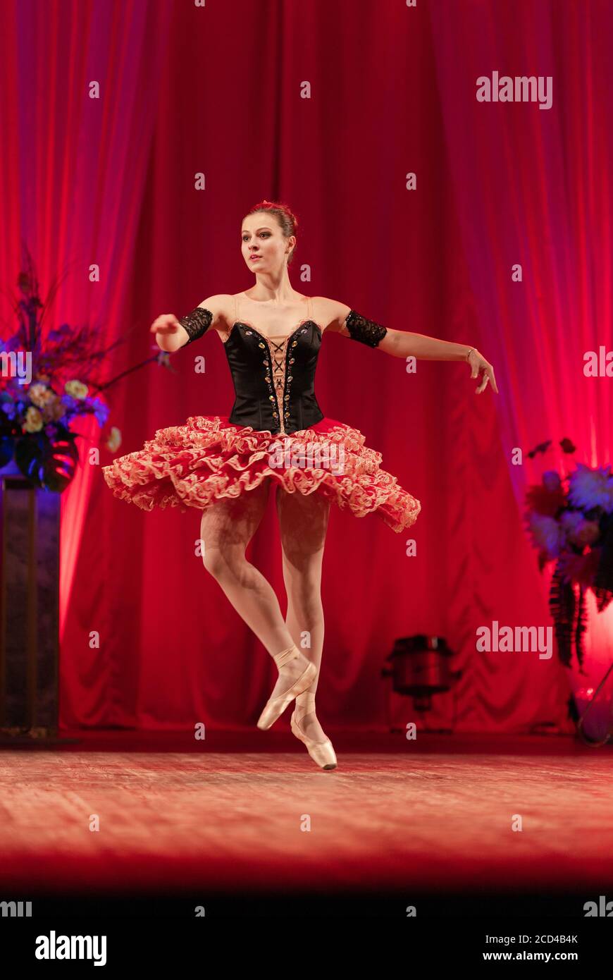 Young female ballerina performing with ballet performance on stage at ...