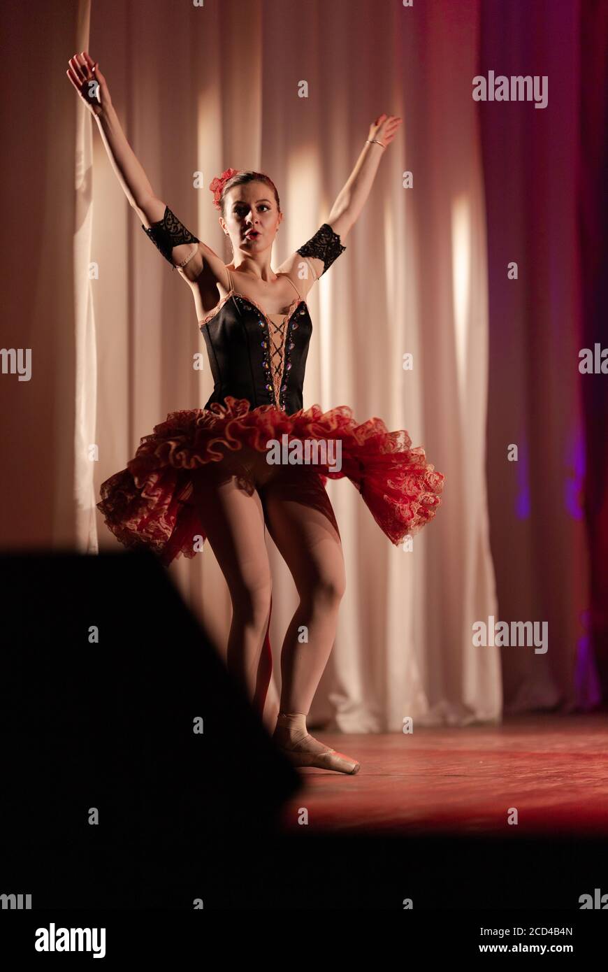 Young female ballerina performing with ballet performance on stage at ...