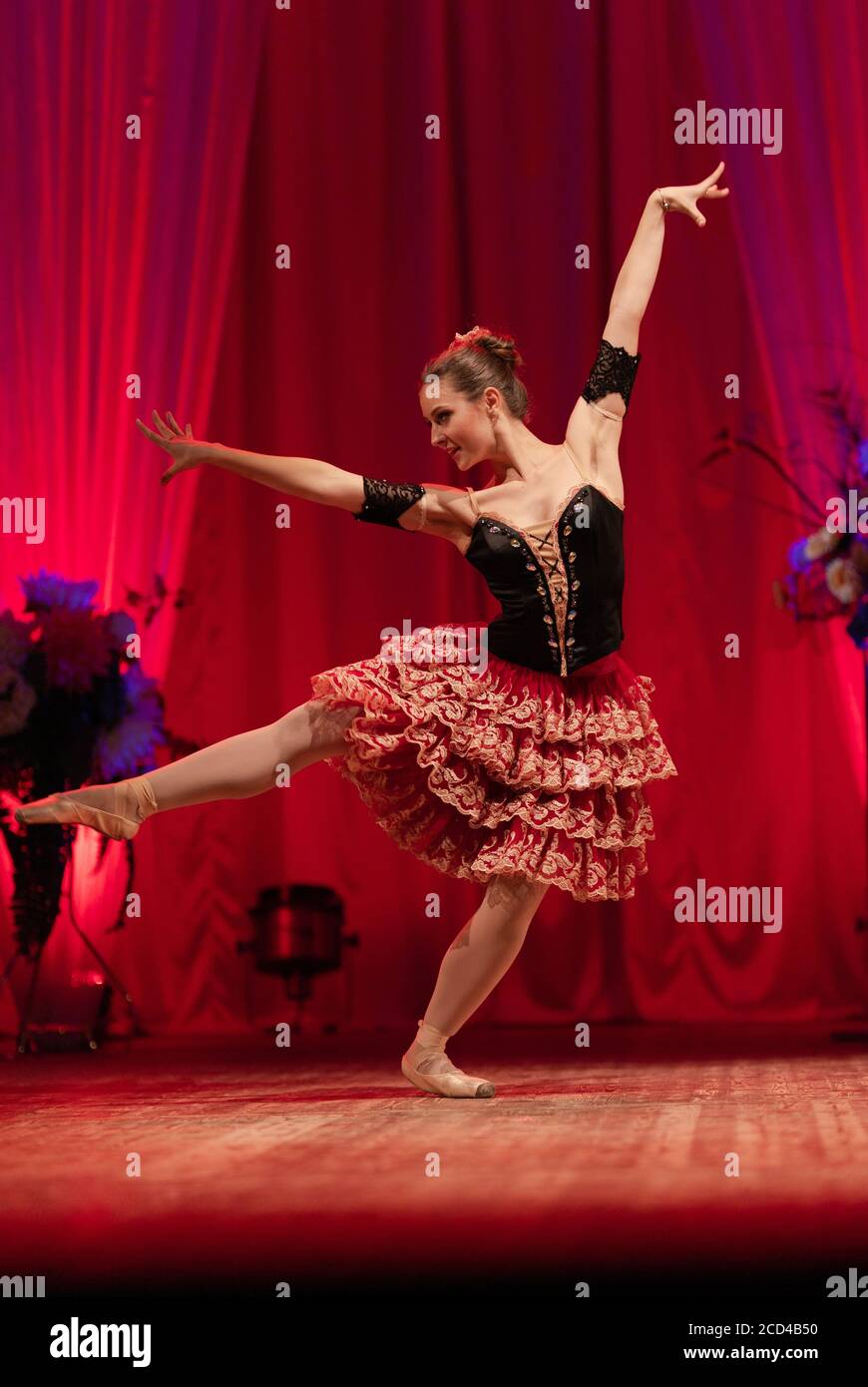 Young female ballerina performing with ballet performance on stage at ...