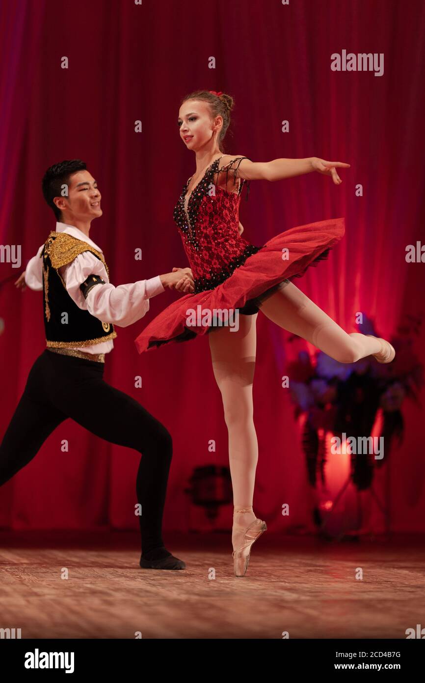Duet young girl ballerina and a young man dancing ballet performance on ...