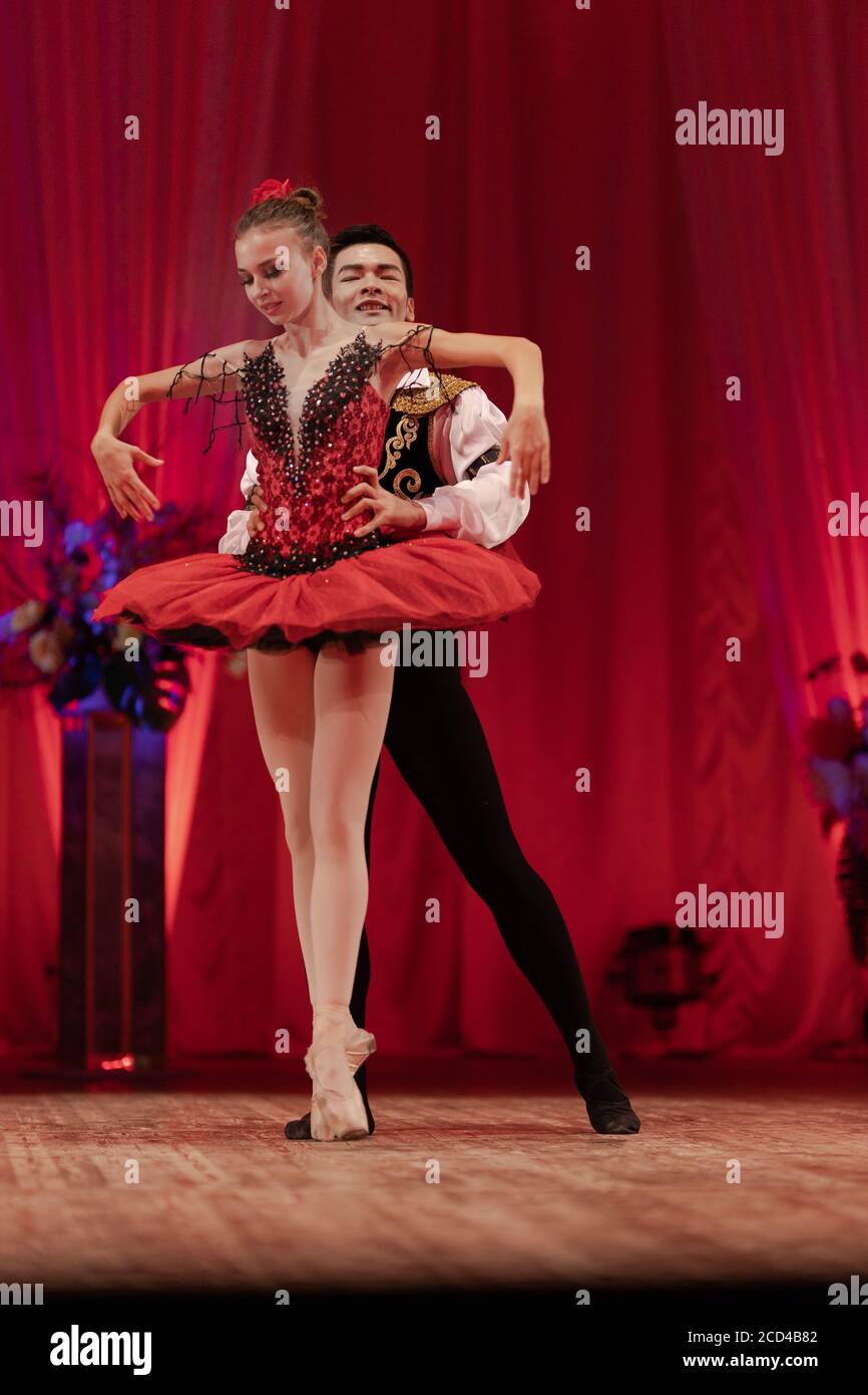 Duet young girl ballerina and a young man dancing ballet performance on ...