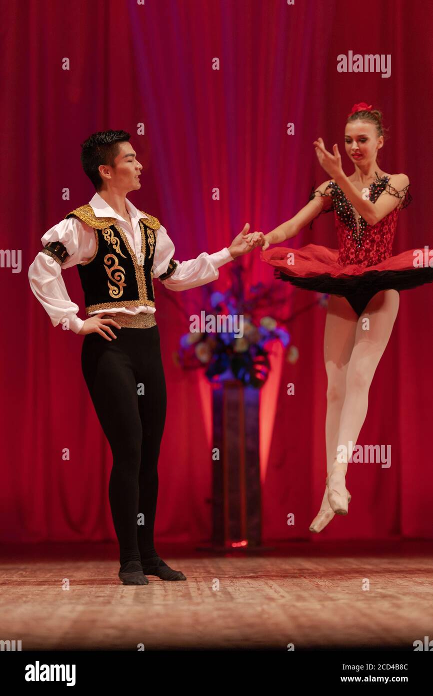 Duet young girl ballerina and a young man dancing ballet performance on ...