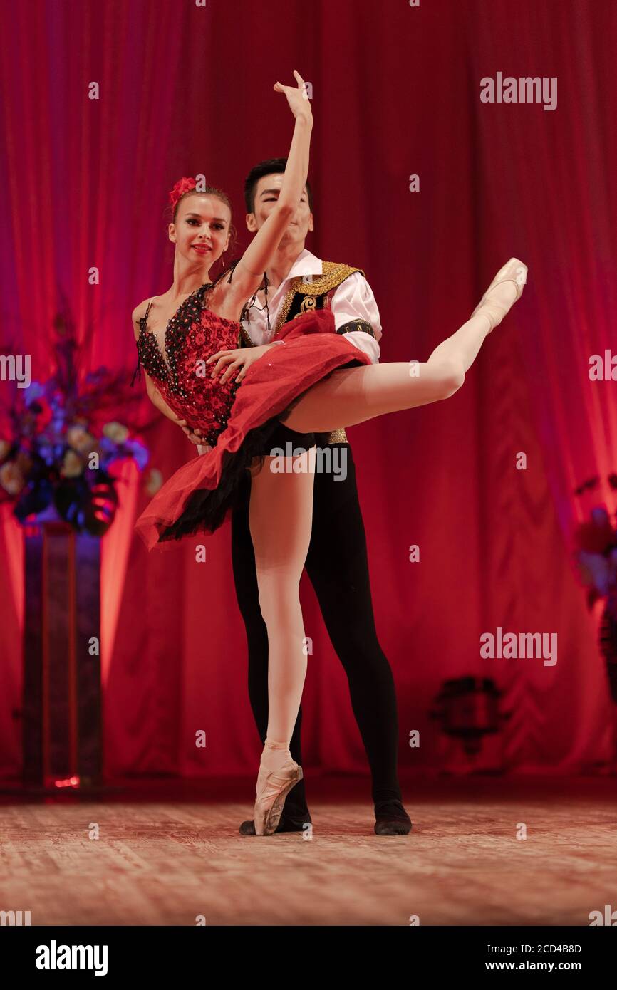 Duet young girl ballerina and a young man dancing ballet performance on ...