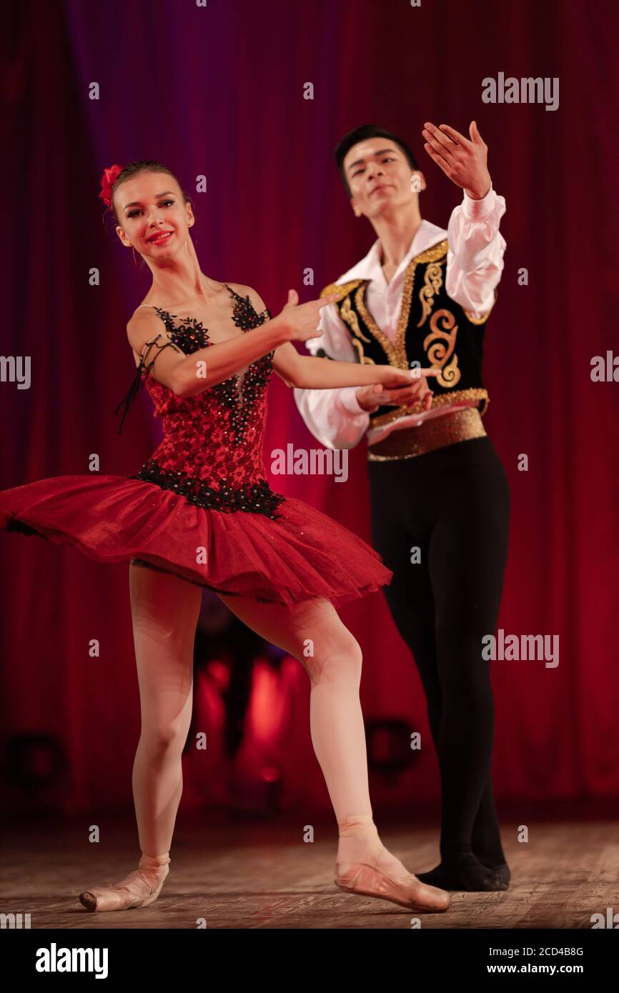 Duet young girl ballerina and a young man dancing ballet performance on ...
