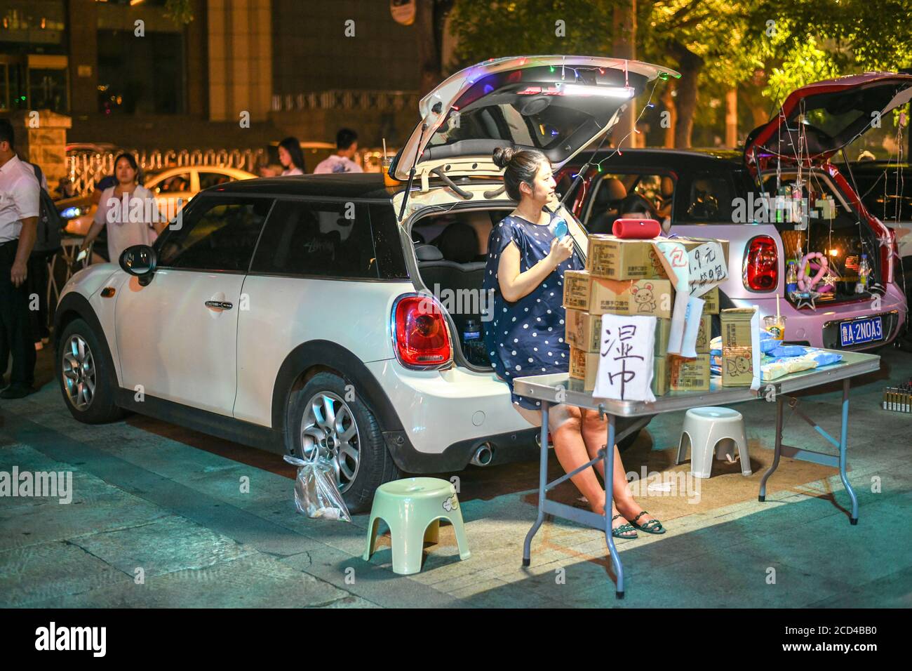 An array of car park and opens their trunk, where various products are ...