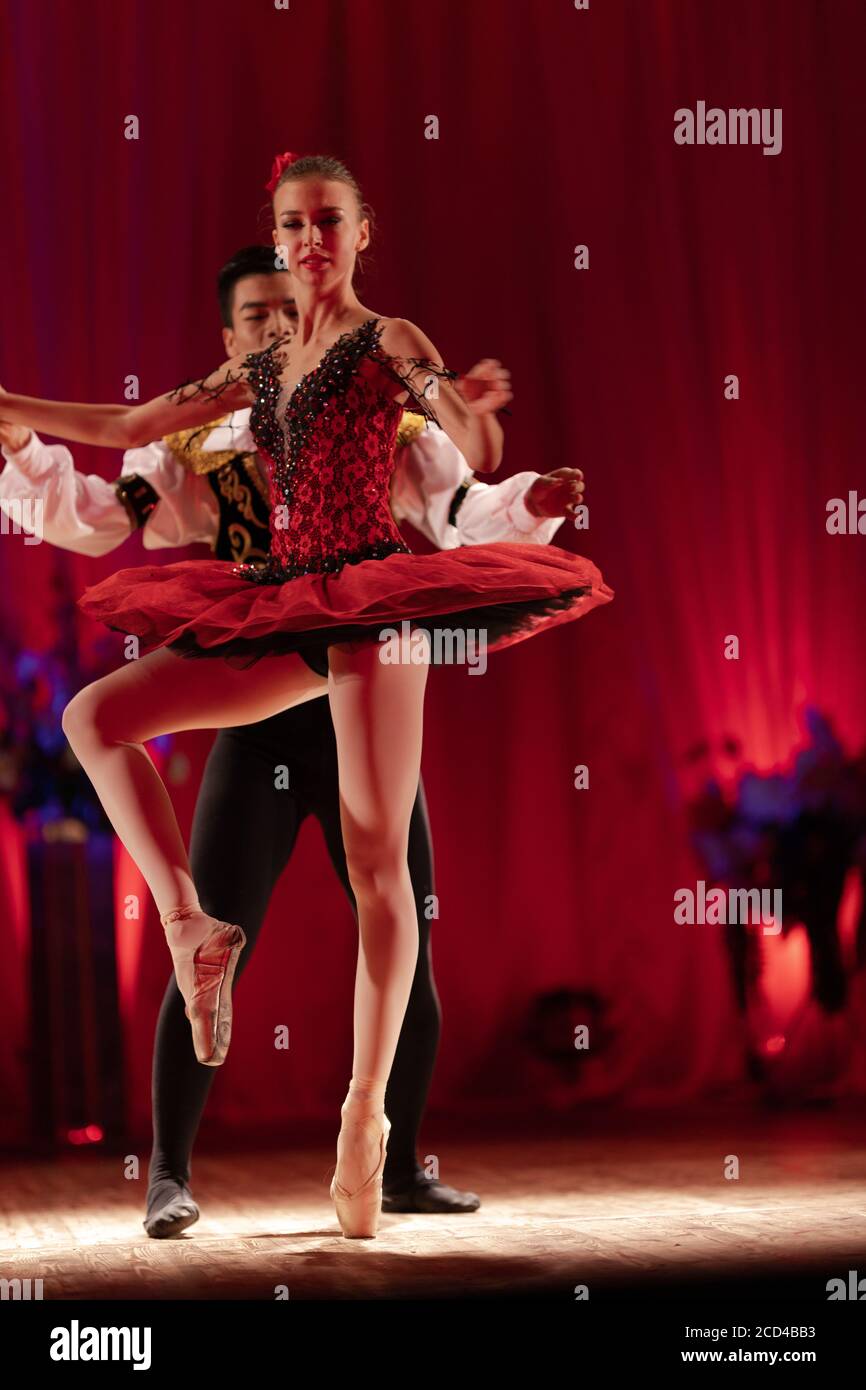 Duet young girl ballerina and a young man dancing ballet performance on ...