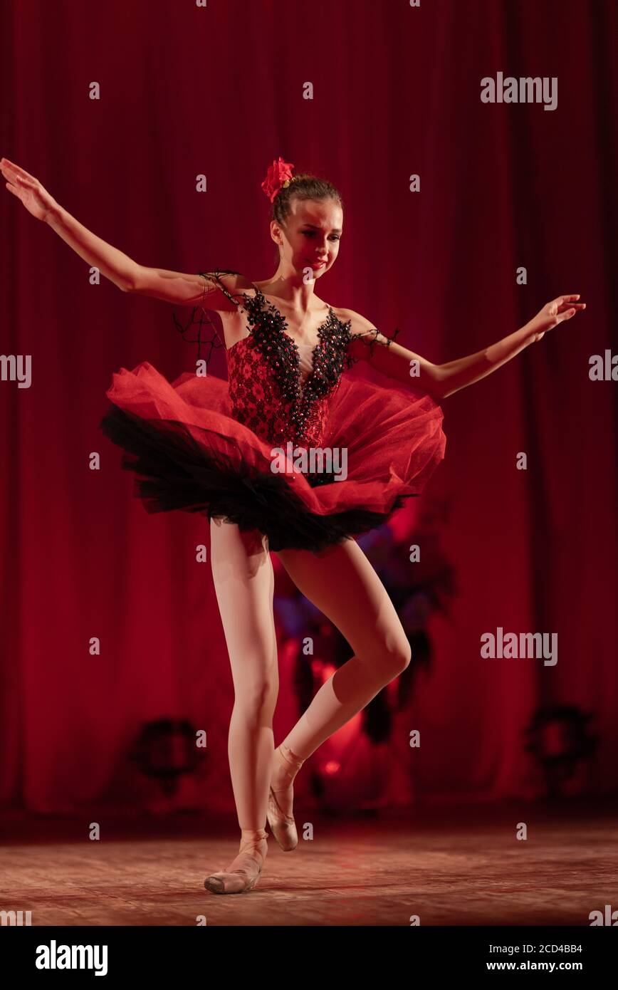 Young female ballerina performing with ballet performance on stage at ...