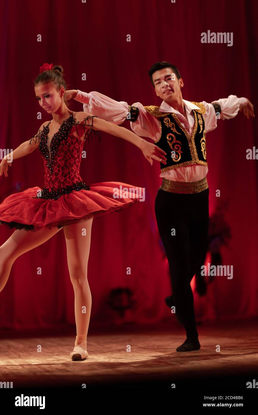 Duet young girl ballerina and a young man dancing ballet performance on ...