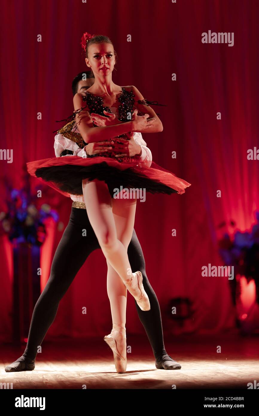 Duet young girl ballerina and a young man dancing ballet performance on ...