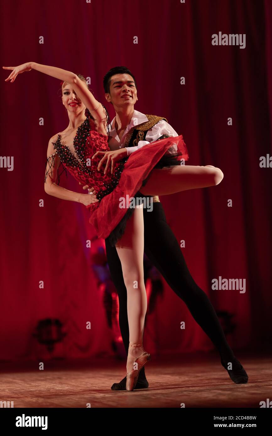 Duet young girl ballerina and a young man dancing ballet performance on ...