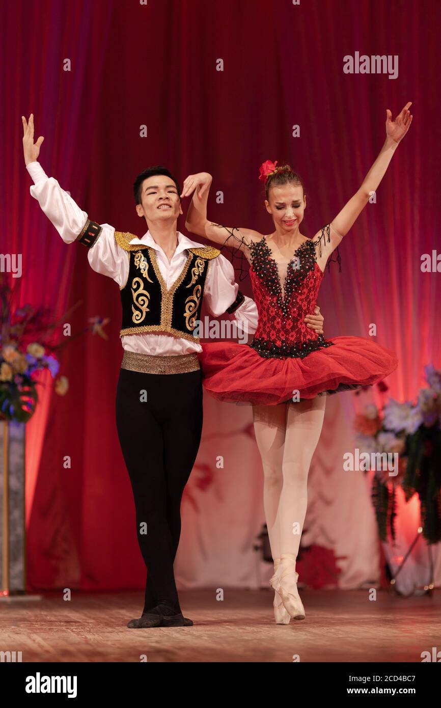 Duet young girl ballerina and a young man dancing ballet performance on ...