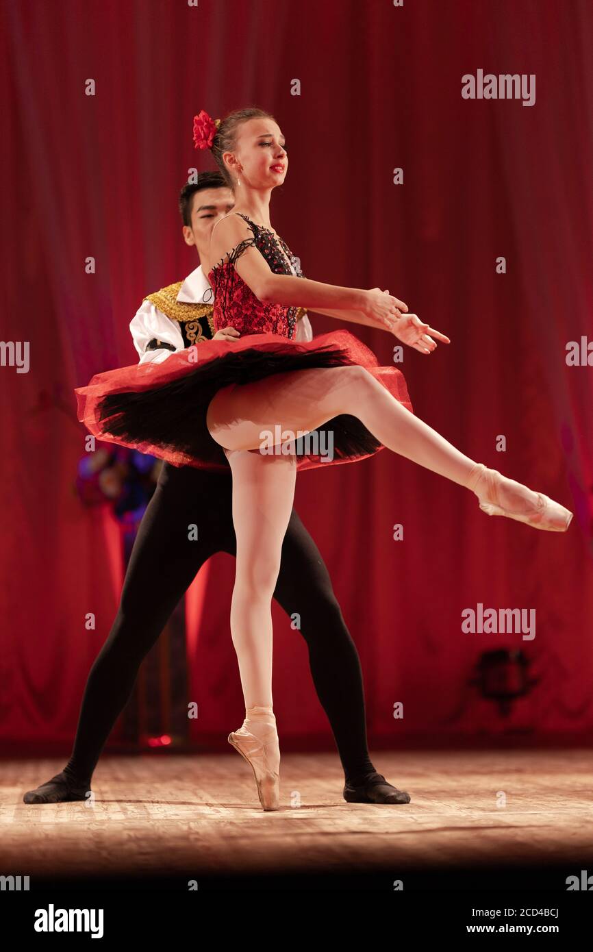 Duet young girl ballerina and a young man dancing ballet performance on ...