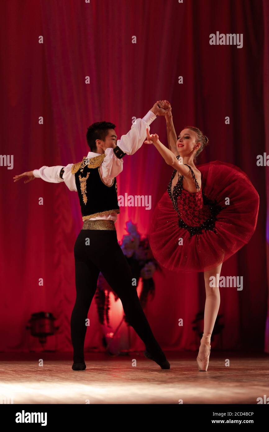 Duet young girl ballerina and a young man dancing ballet performance on ...