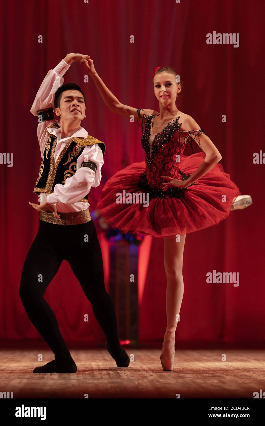 Duet young girl ballerina and a young man dancing ballet performance on ...