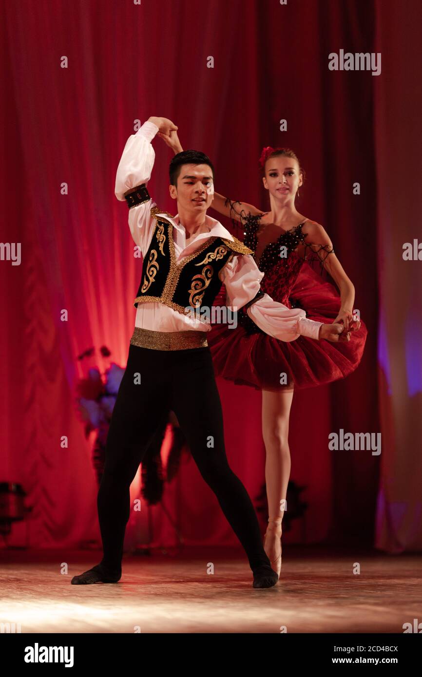 Duet young girl ballerina and a young man dancing ballet performance on ...
