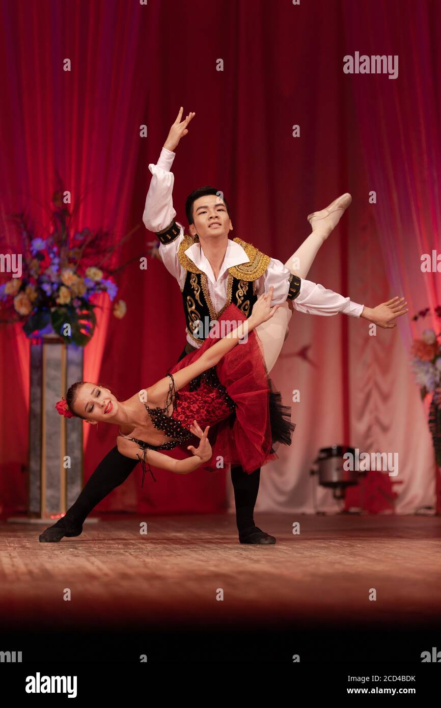 Duet young girl ballerina and a young man dancing ballet performance on ...
