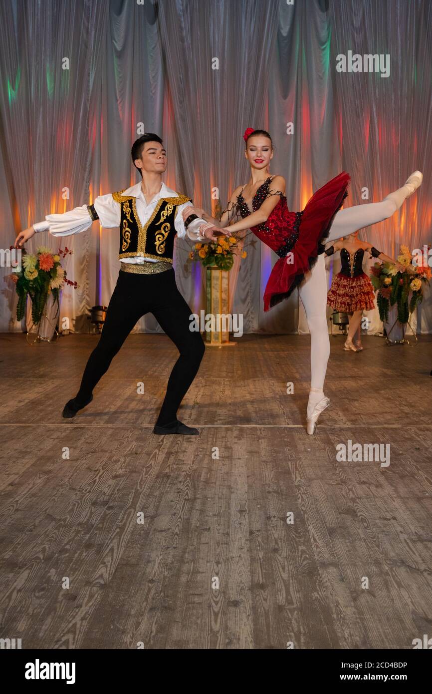 Duet young girl ballerina and a young man dancing ballet performance on ...
