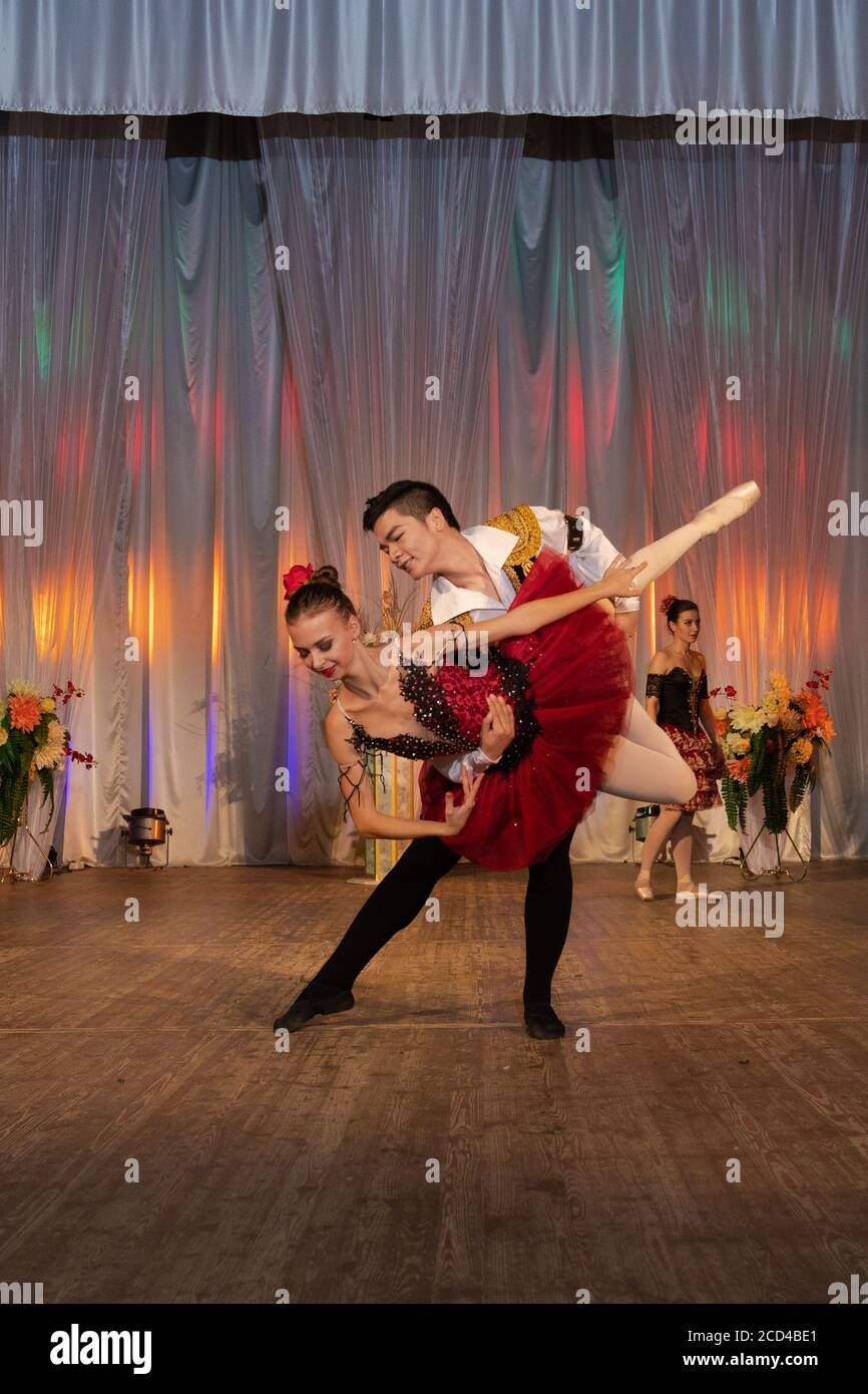 Duet young girl ballerina and a young man dancing ballet performance on ...