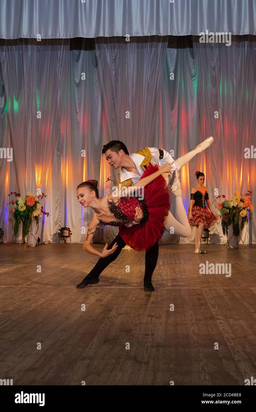 Duet young girl ballerina and a young man dancing ballet performance on ...