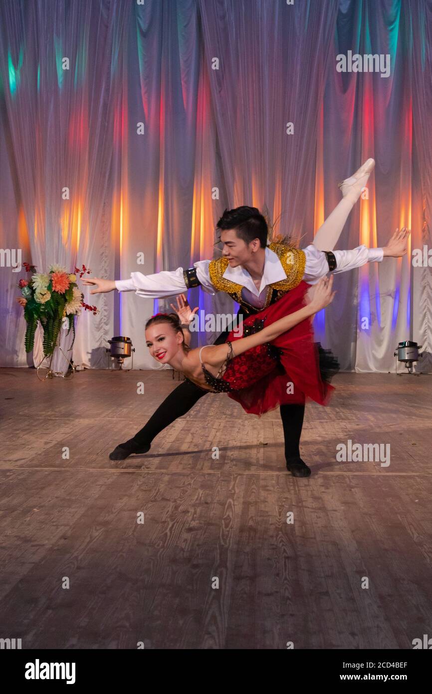 Duet young girl ballerina and a young man dancing ballet performance on ...