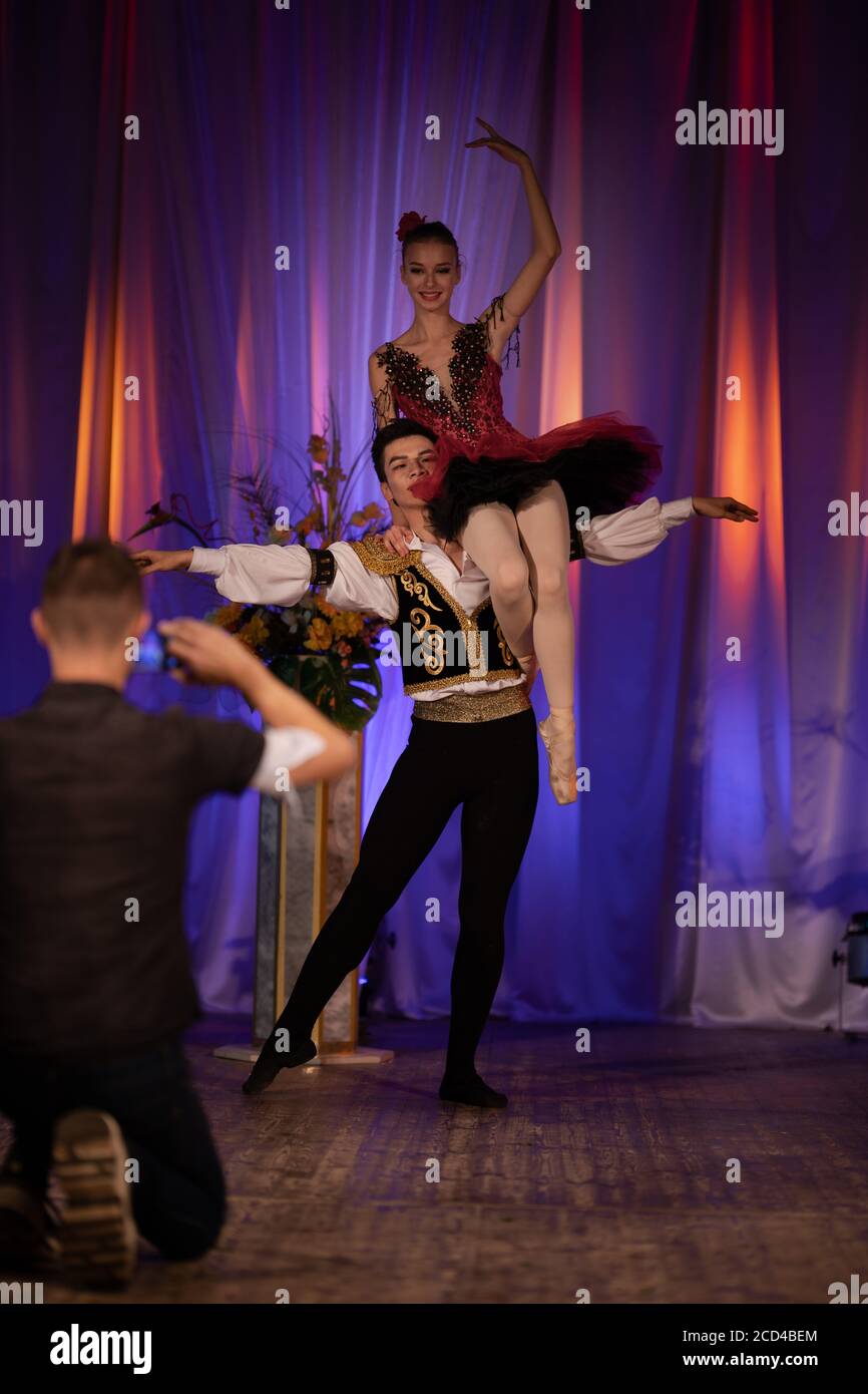 Duet young girl ballerina and a young man dancing ballet performance on ...