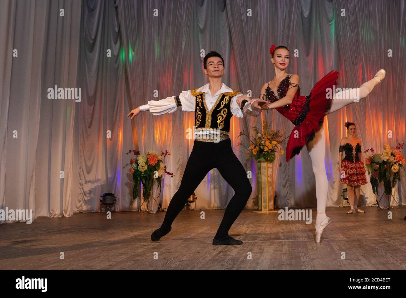 Duet young girl ballerina and a young man dancing ballet performance on ...