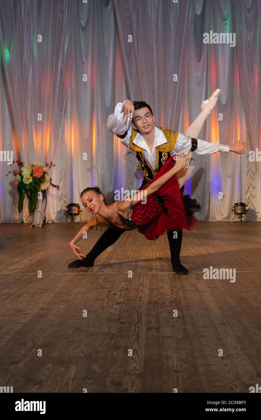 Duet young girl ballerina and a young man dancing ballet performance on ...