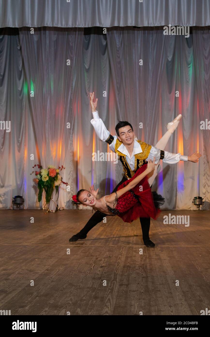 Duet young girl ballerina and a young man dancing ballet performance on ...