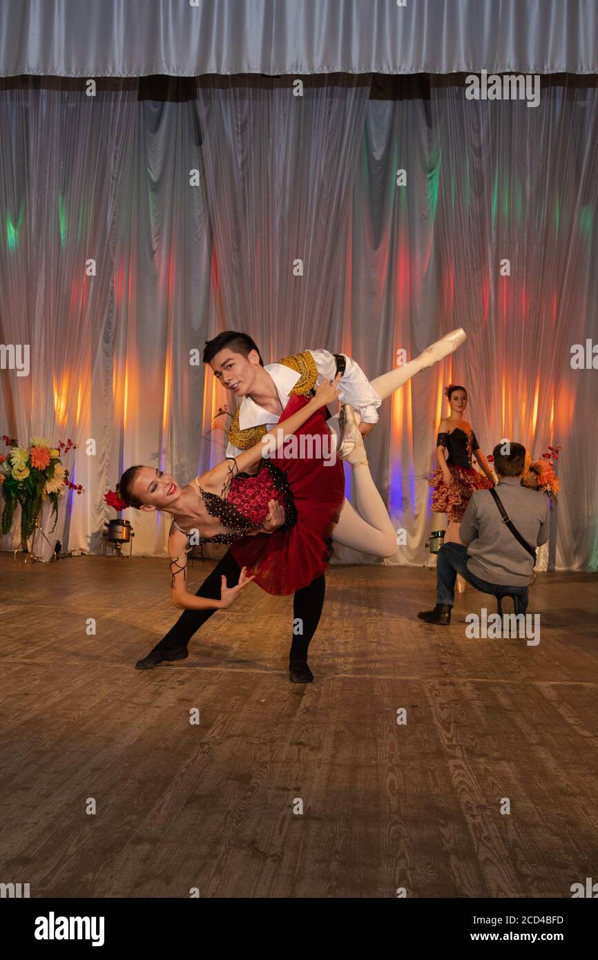 Duet young girl ballerina and a young man dancing ballet performance on ...