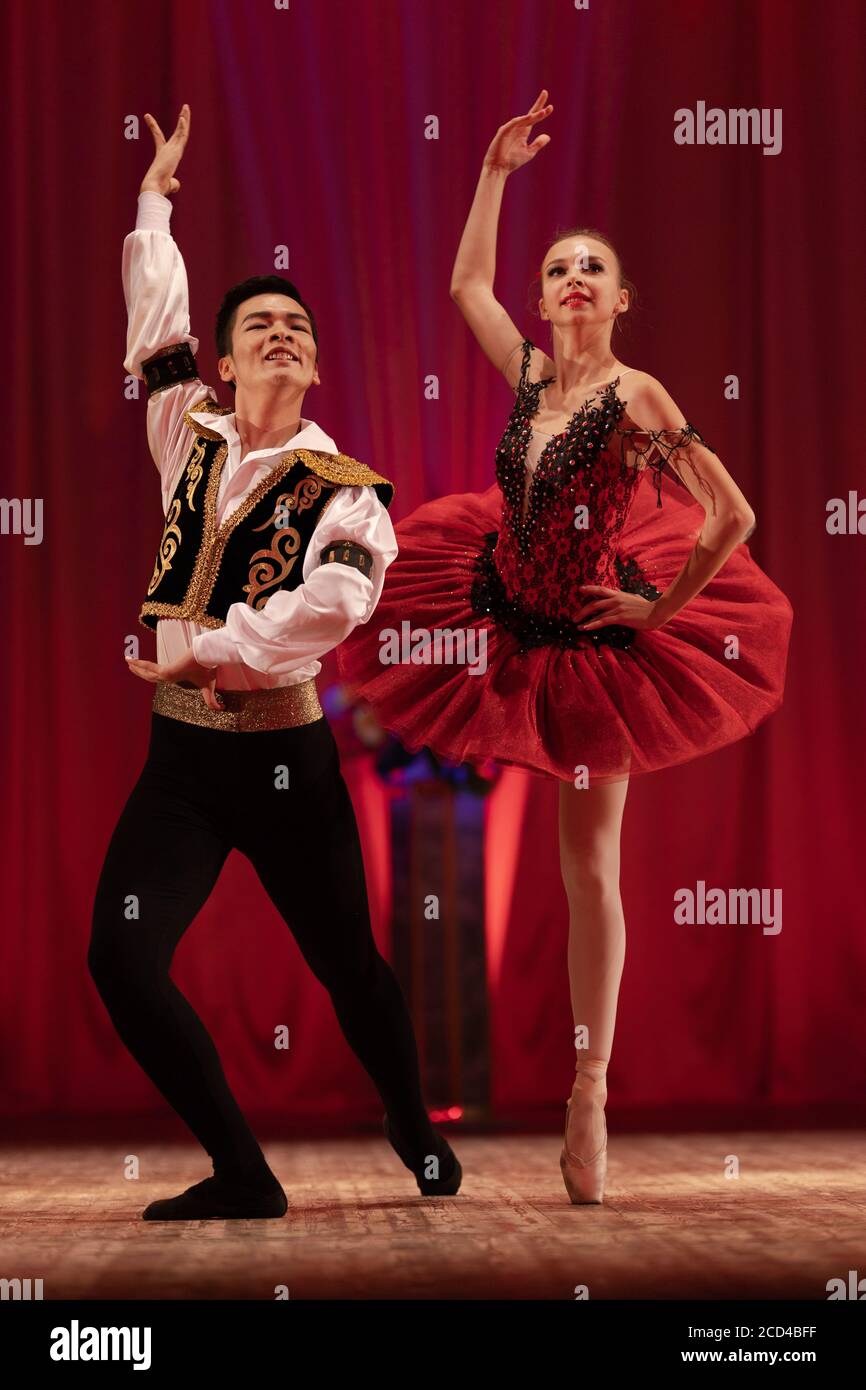 Duet young girl ballerina and a young man dancing ballet performance on ...