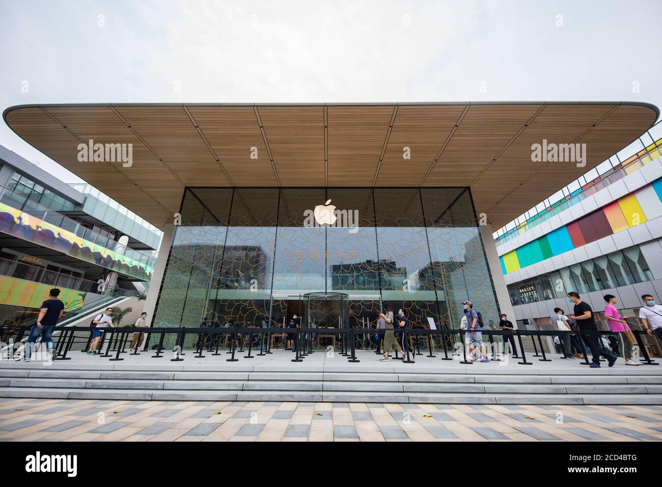 People line up to get inside the newly-opened Apple Store at Sanlitun ...