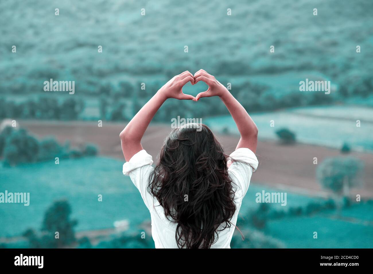 young girl making heart with hand stock image Stock Photo - Alamy