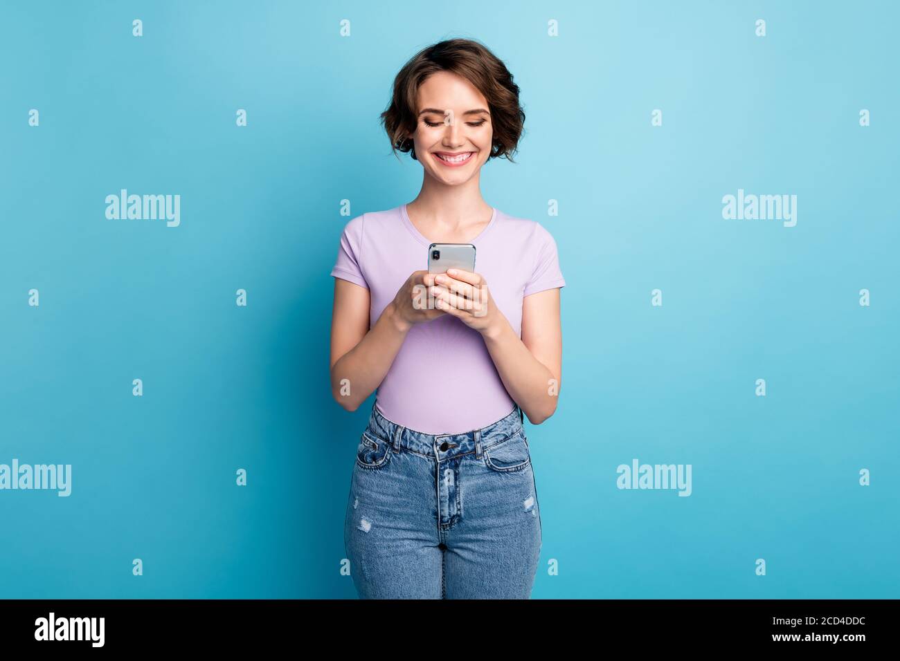 Photo of positive cheerful girl use smartphone enjoy read repost share ...