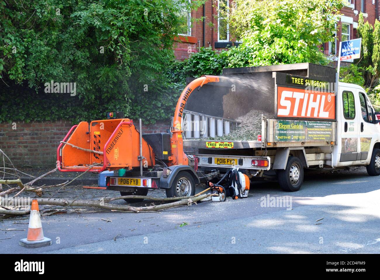 Chopped up tree branches fed into back of truck hi-res stock ...