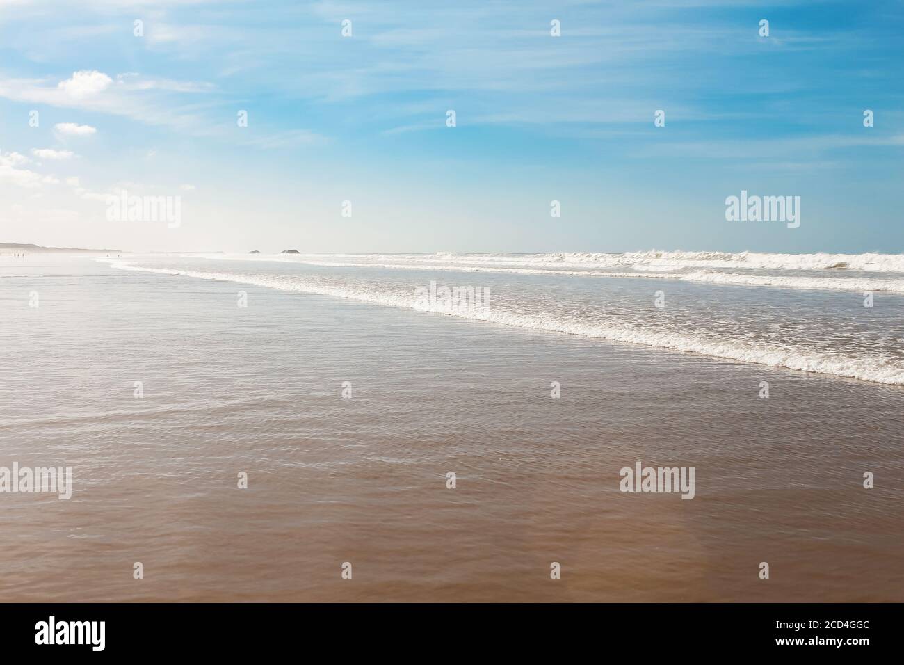 View over sandy beach of Atlantic ocean with waves coming in perfect ...