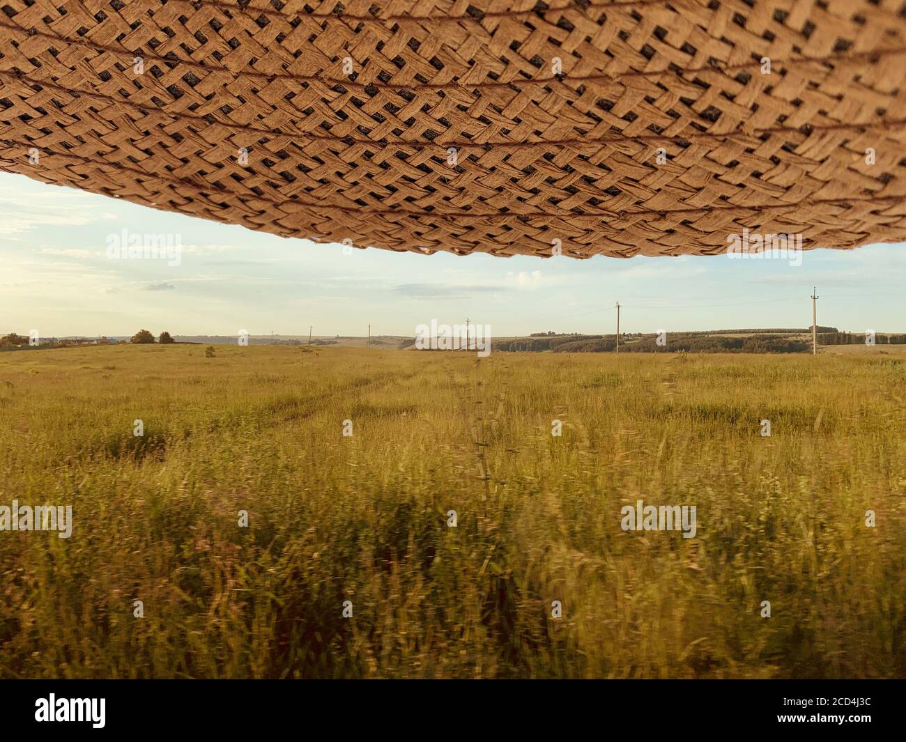 Meadow. Countriside tourism. View under a hat Stock Photo - Alamy