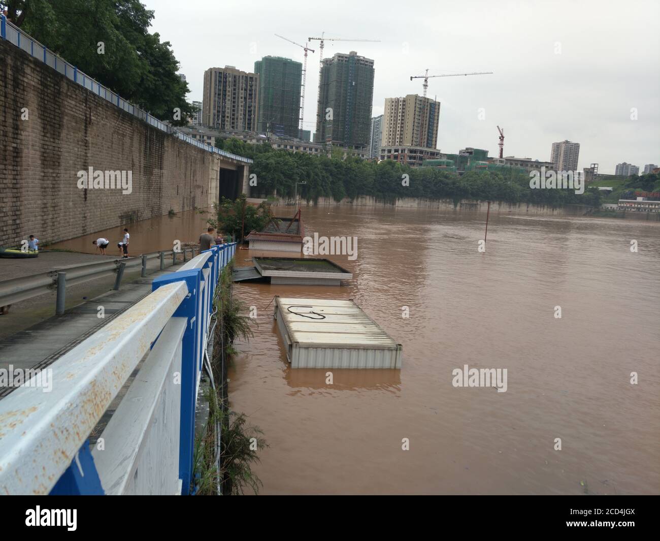 Some of the low-lying aeras near the river are flooded by rising water ...