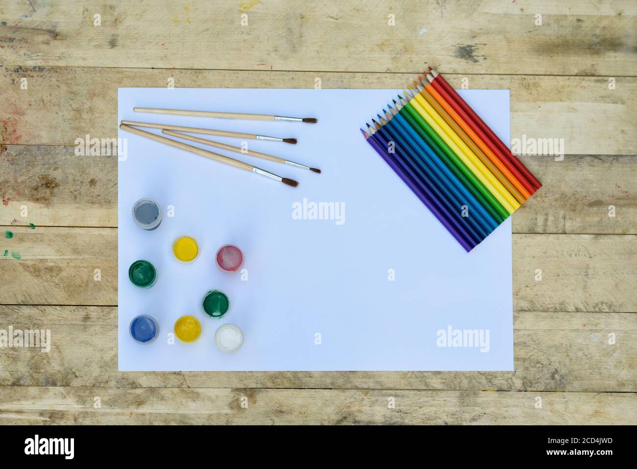 Art concept. Blank sheet of paper, paint, brushes and colored pencils ...