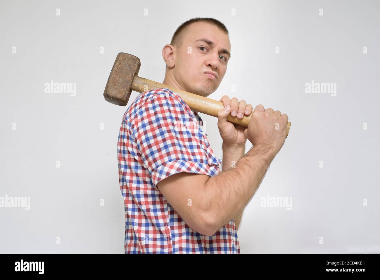 Man with a sledgehammer on a white background. Work concept Stock Photo ...