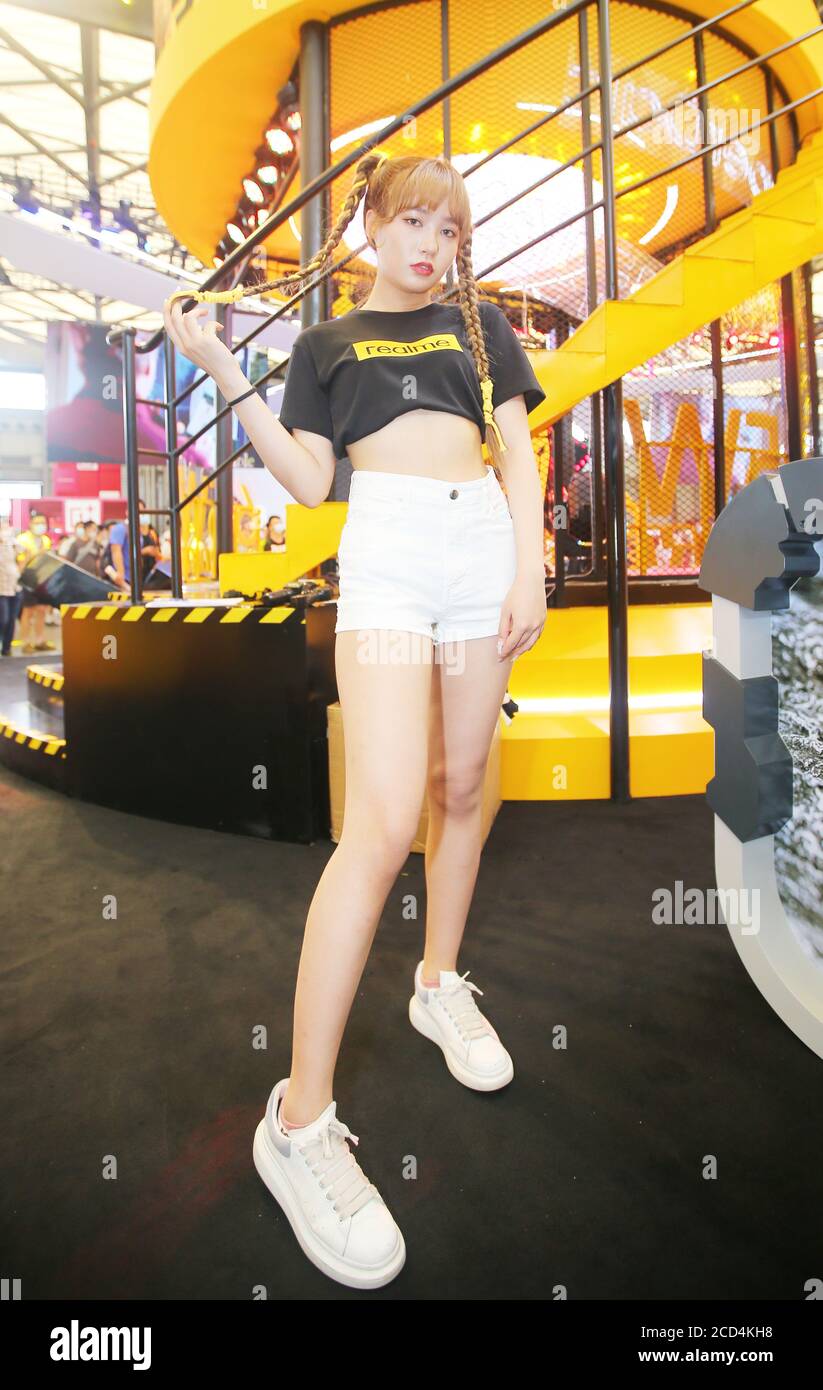 Beautiful cosplayers are seen posing and performing in clothes shown in ...